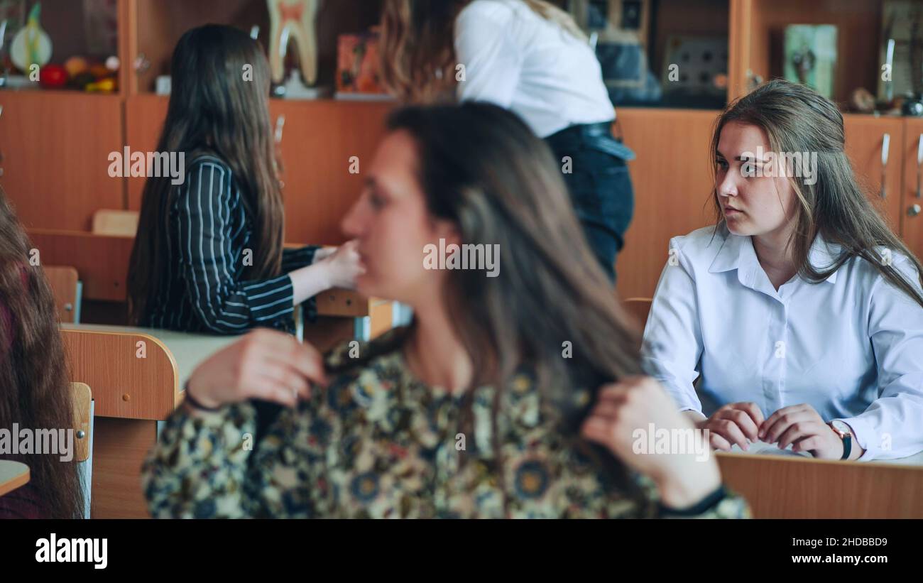Students in the classroom at their desks in front of the're coming out ...