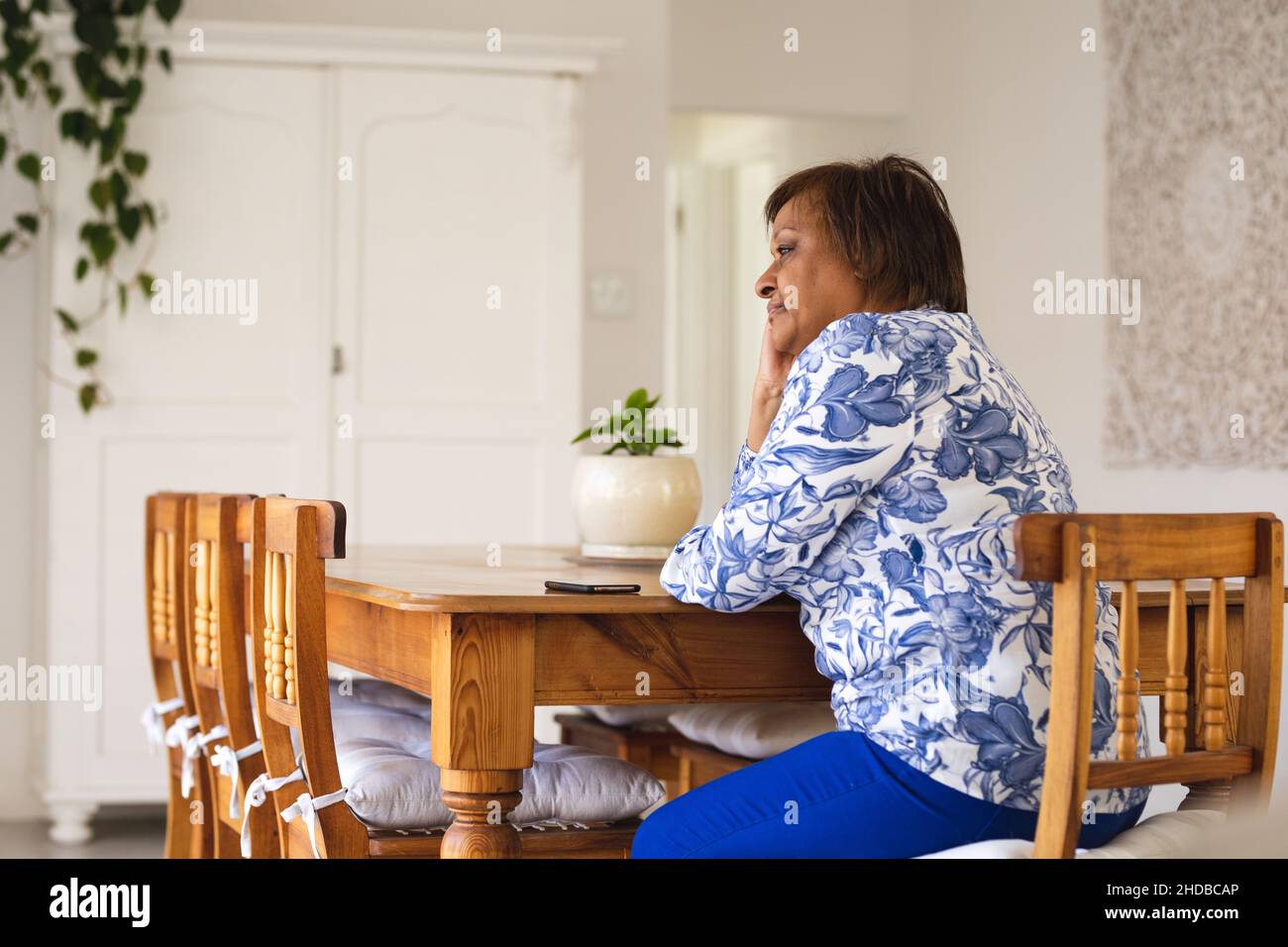 Young woman sitting dining table hi-res stock photography and images ...