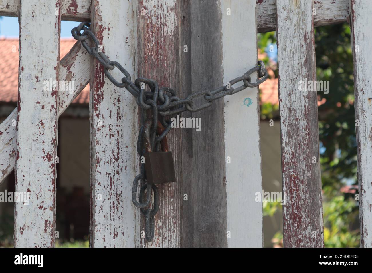 Wooden gate locked with chain and padlock Stock Photo - Alamy
