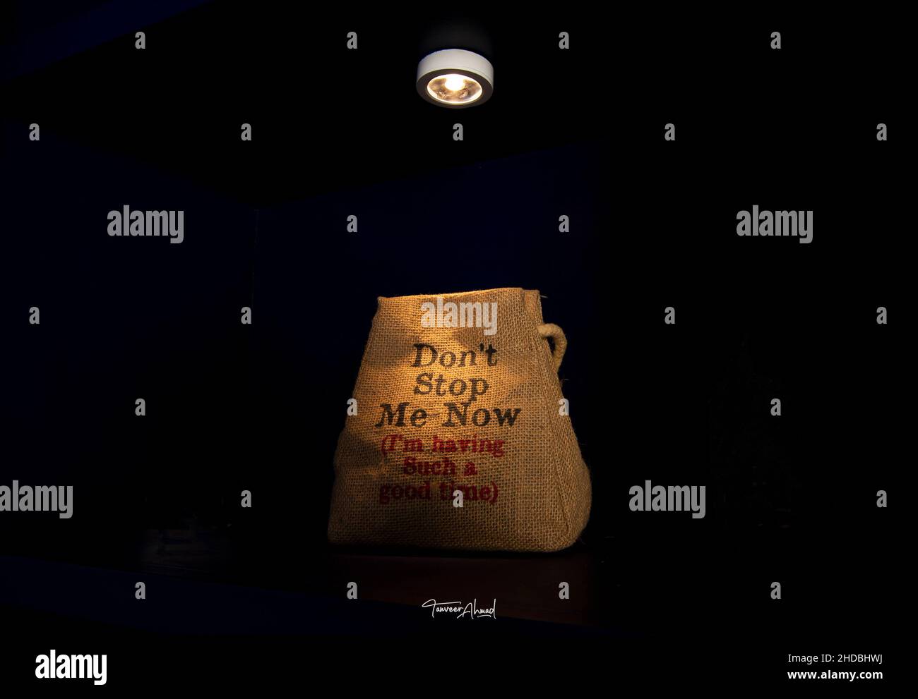 Jute fabric box with motivation quote and spot light Stock Photo - Alamy