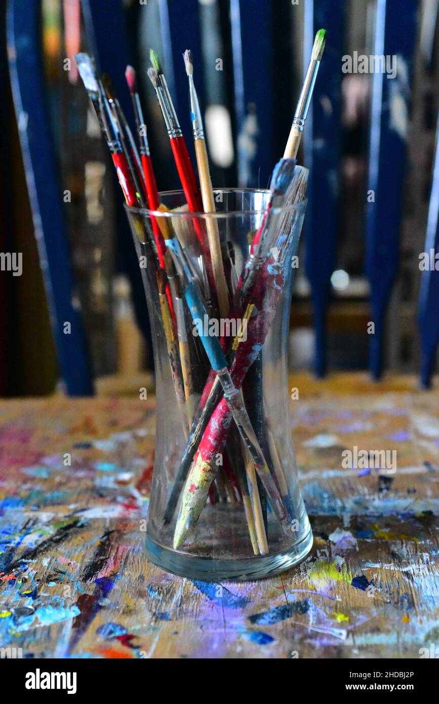 Shallow focus of an Artist's pallet, colours, paint, pain brushes ...