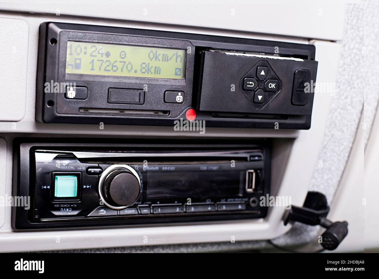 Digital tachograph with a printer pop out. Car radio and telephone ...