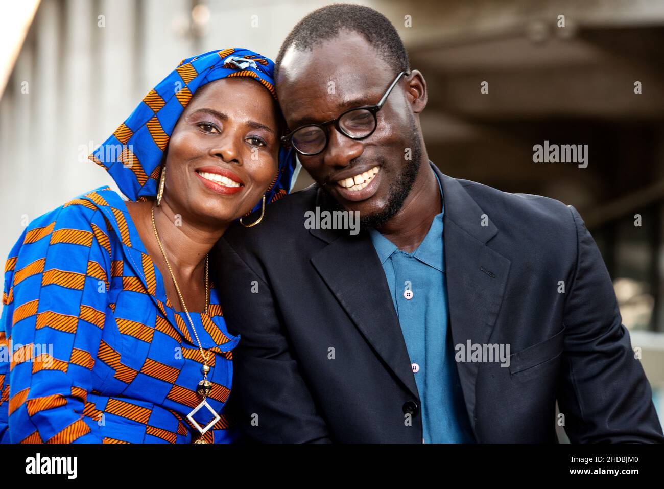 beautiful african couple sitting outdoors embracing looking at the ...
