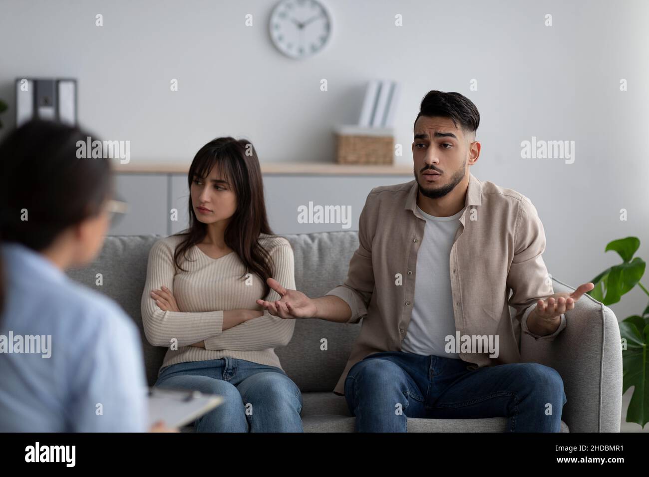 Female psychologist giving therapy session to stressed arab couple ...