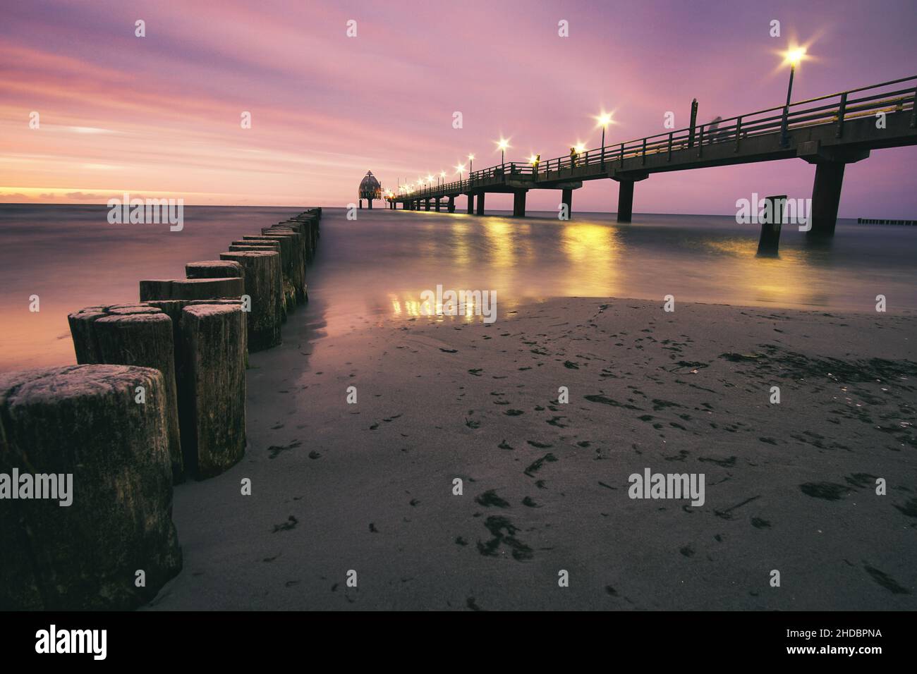 the pier in Zingst on the Baltic Sea, with a long exposure and purple ...