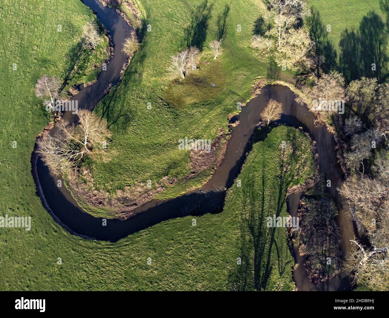 An aerial view of the river Arrow in winter running through twists and ...