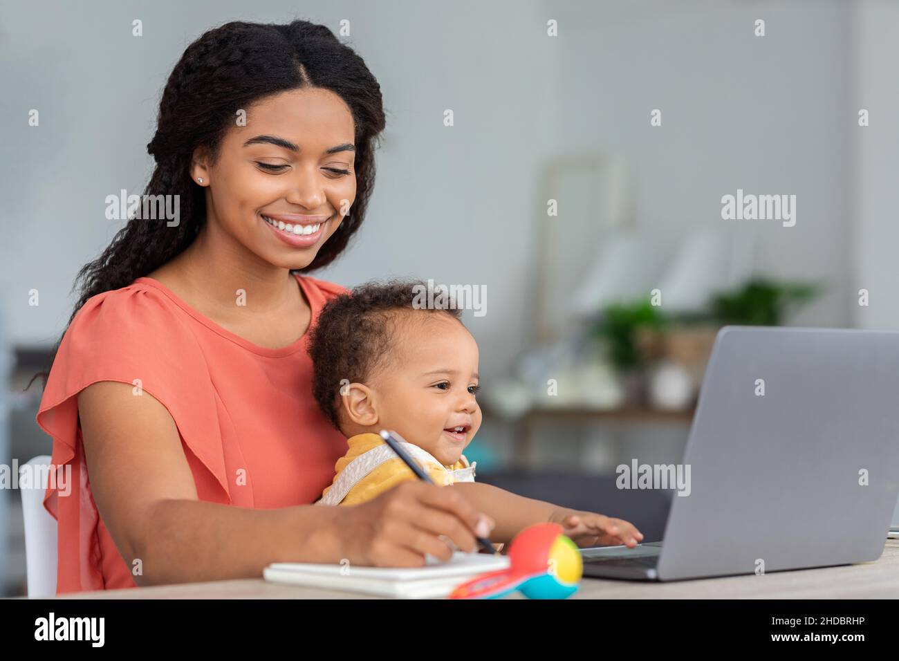 Motherhood And Education. Young Black Woman With Baby On Hands Study ...