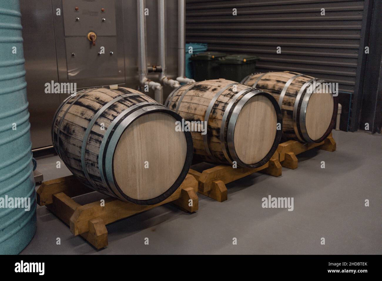 old oak wood barrels with beer in the underground cellar Stock Photo ...