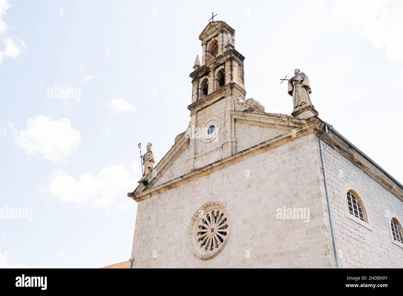 Church of St. Nicholas with statues on the roof and a rose window in ...