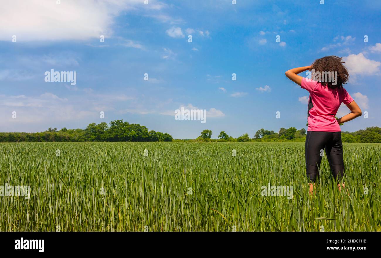 Rear view of young woman girl female runner jogger running standing in ...