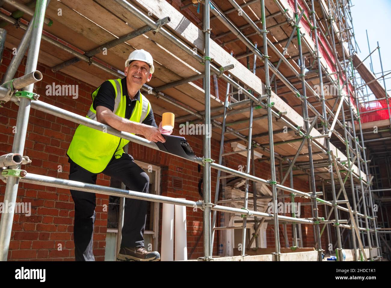 Construction worker holding hard hat hi-res stock photography and ...