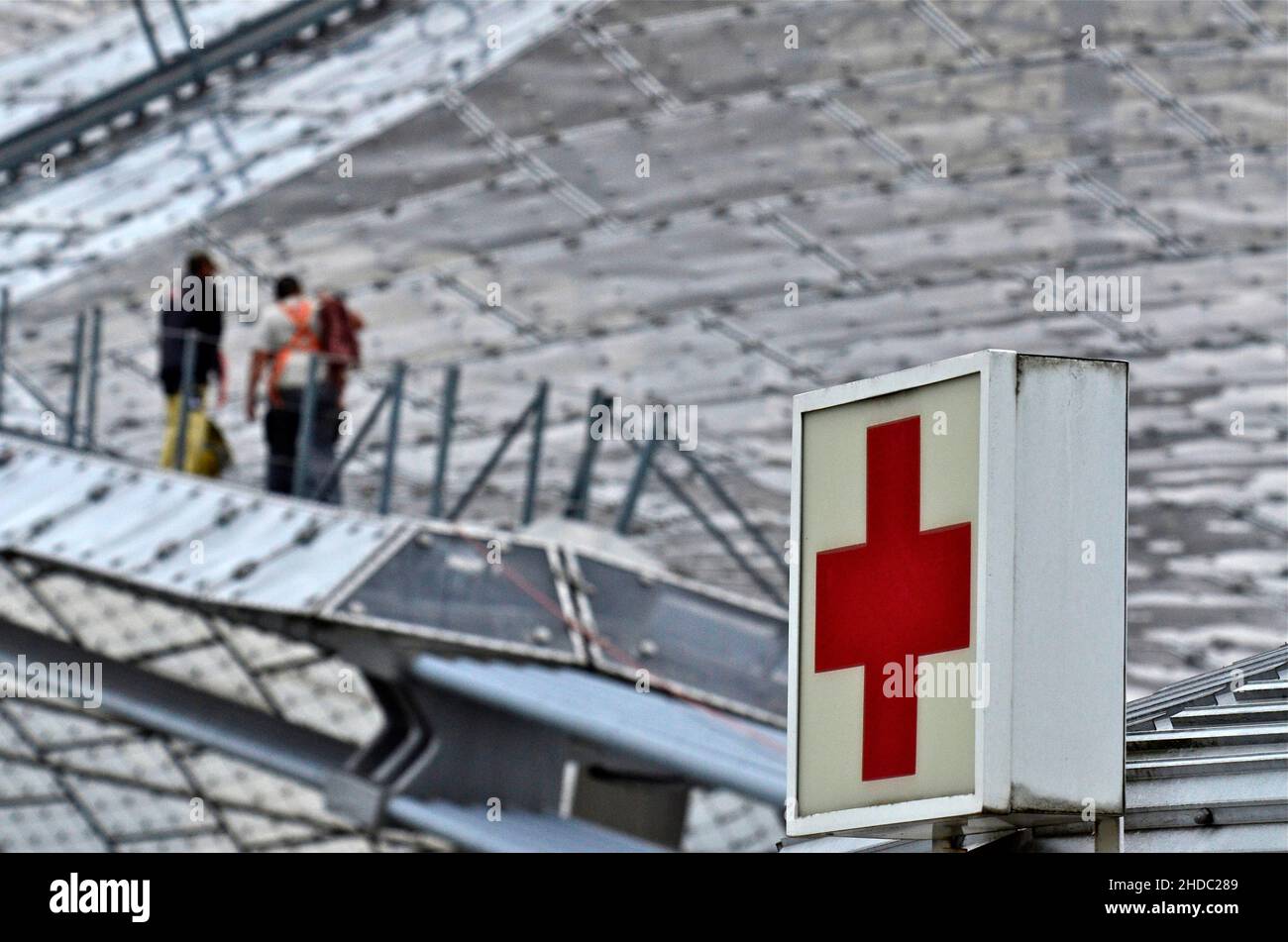 Worker on roof of Olympic tent with Red Cross sign, Olympiapark, Munich ...