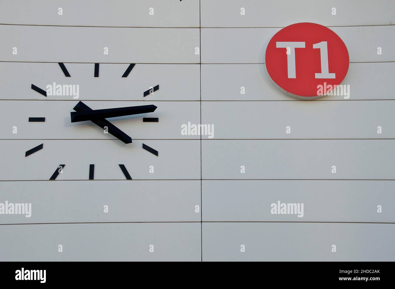 Alicante Airport Wall Clock with T1 Advertising Stock Photo - Alamy