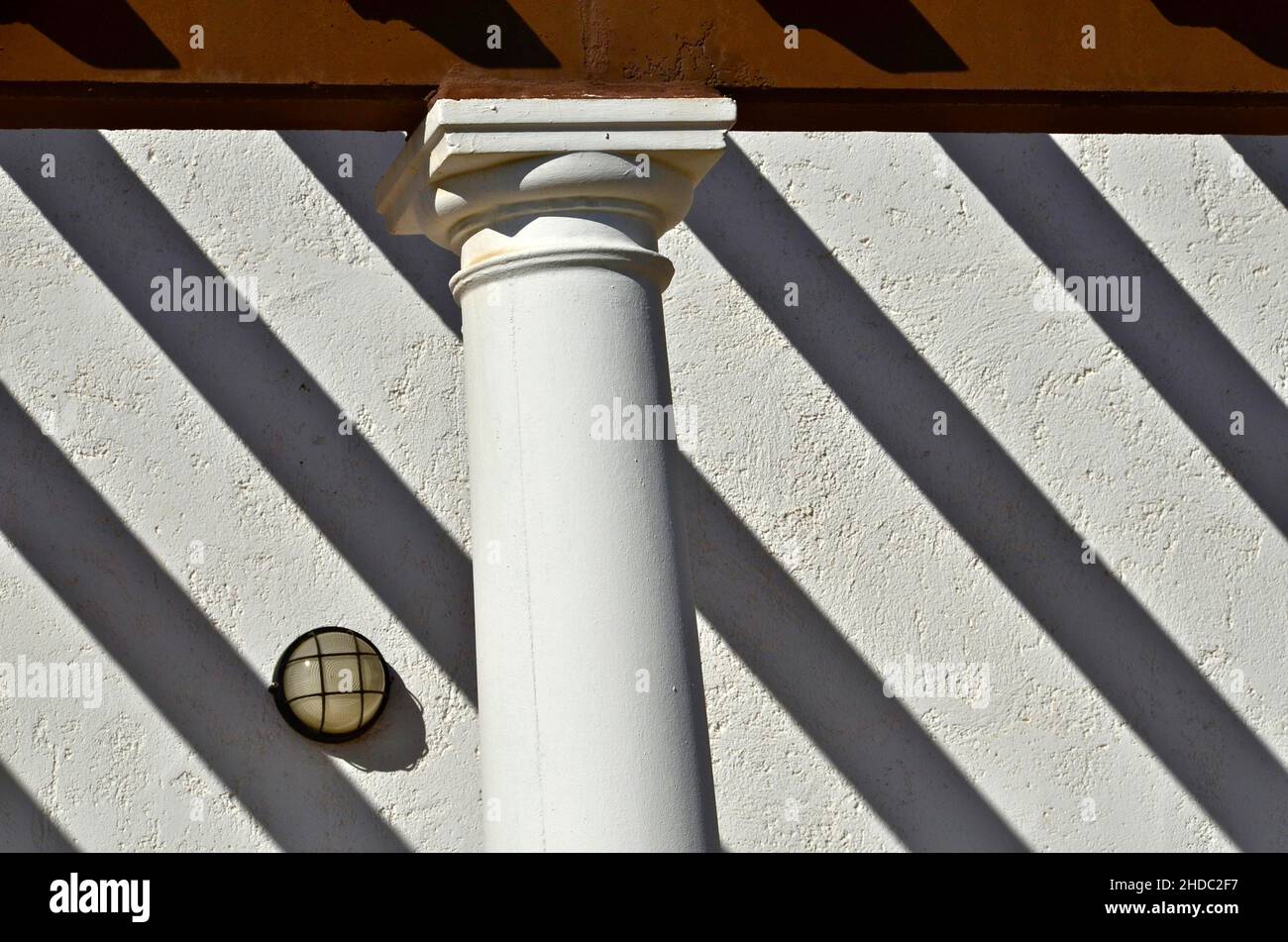 Column with lamp and shadow on house wall Stock Photo - Alamy