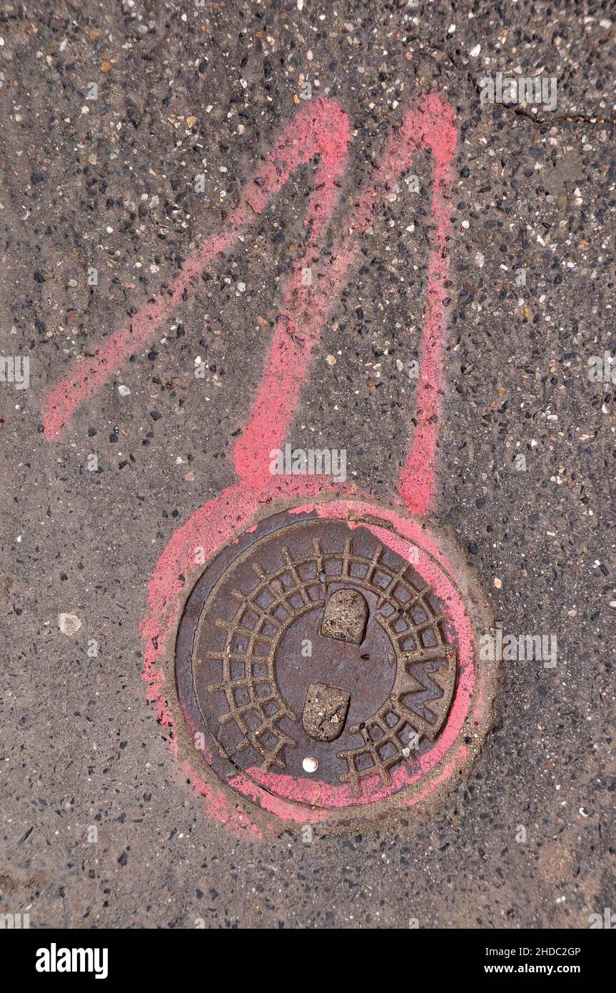 Manhole cover lid and number 11 in pink Stock Photo - Alamy