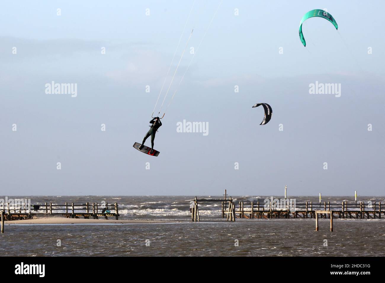 St. Peter Ording, Germany. 05th Jan, 2022. Kite surfers are on the ...