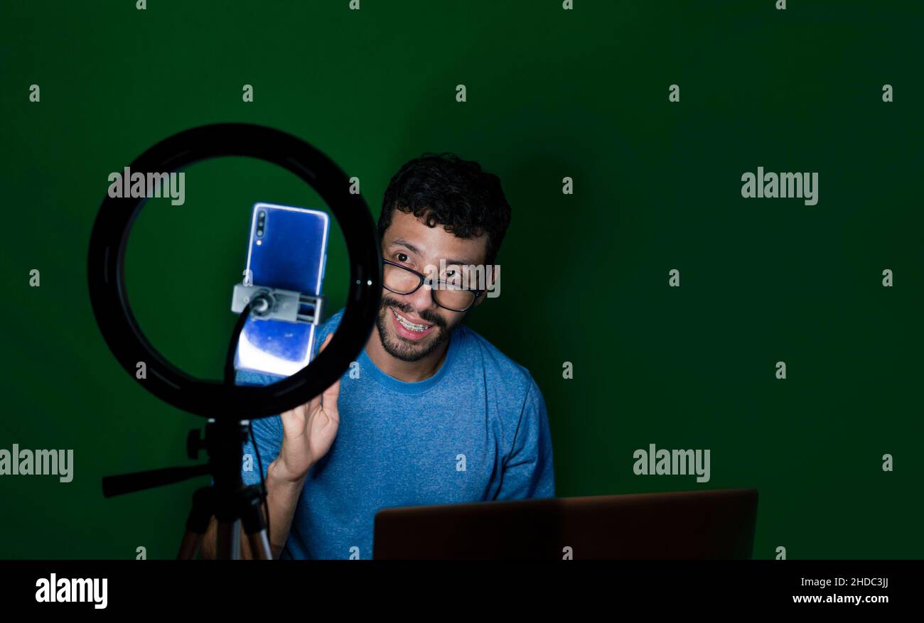 Young man with laptop making video blog, Young man, content creator ...