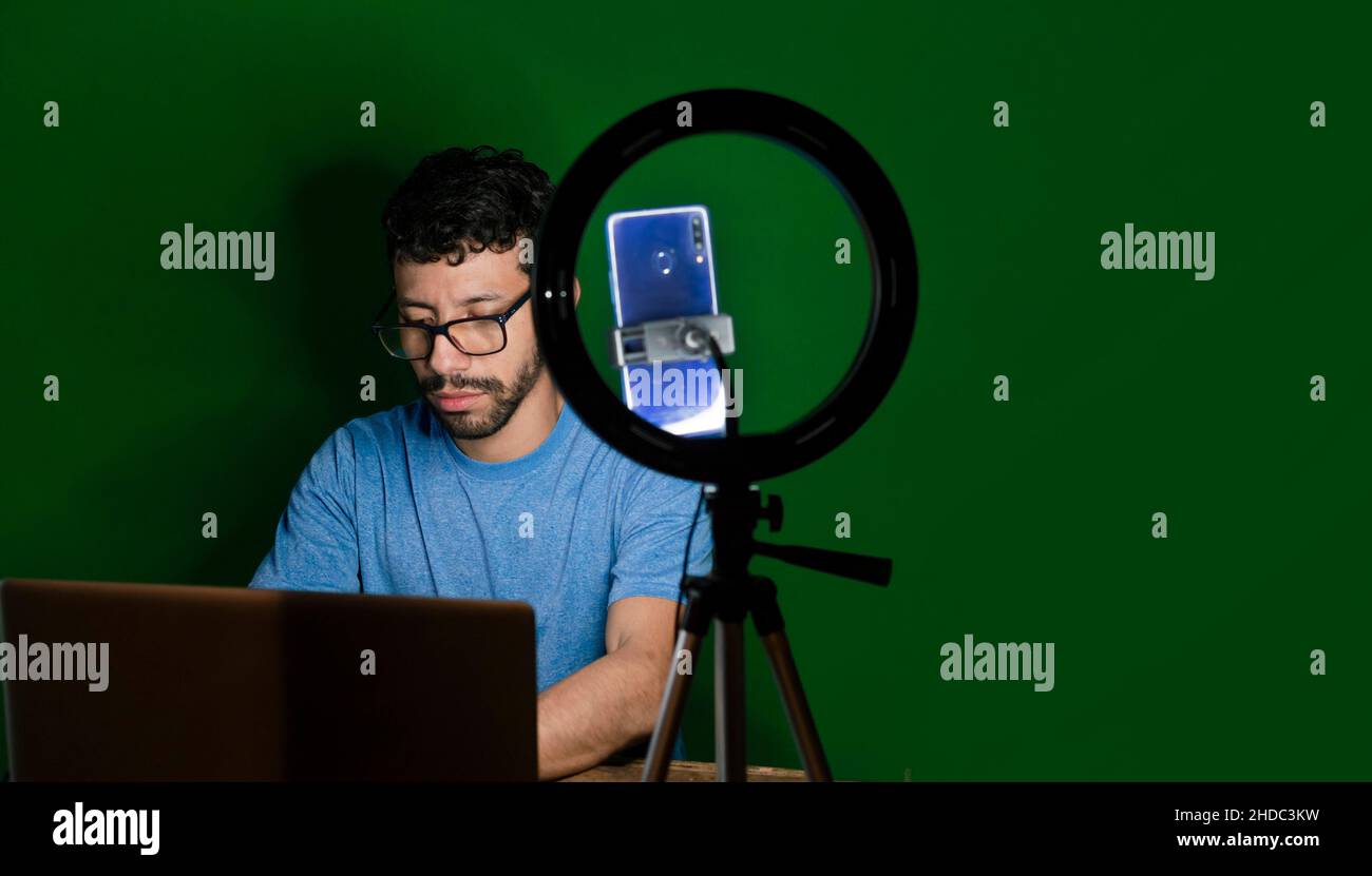 Young man with laptop making video blog, Young man, content creator ...