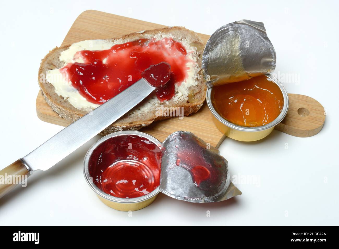 Slice of bread with jam and jam in portion pack, jam Stock Photo - Alamy