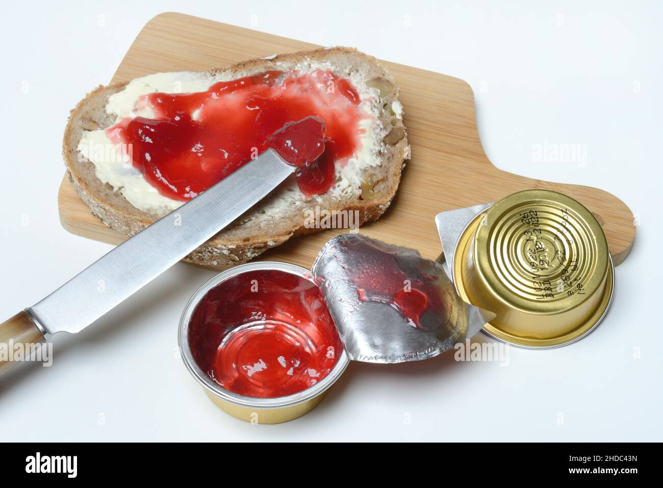 Slice of bread with jam and jam in portion pack, jam Stock Photo - Alamy