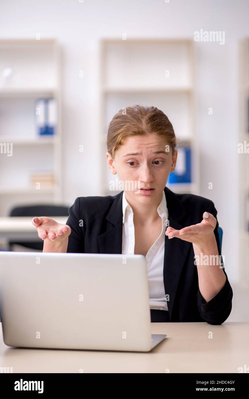 Female employee sitting at workplace Stock Photo - Alamy