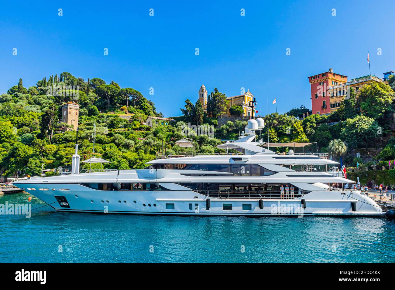 Luxury yacht anchored in the harbour of Portofino behind the church of ...