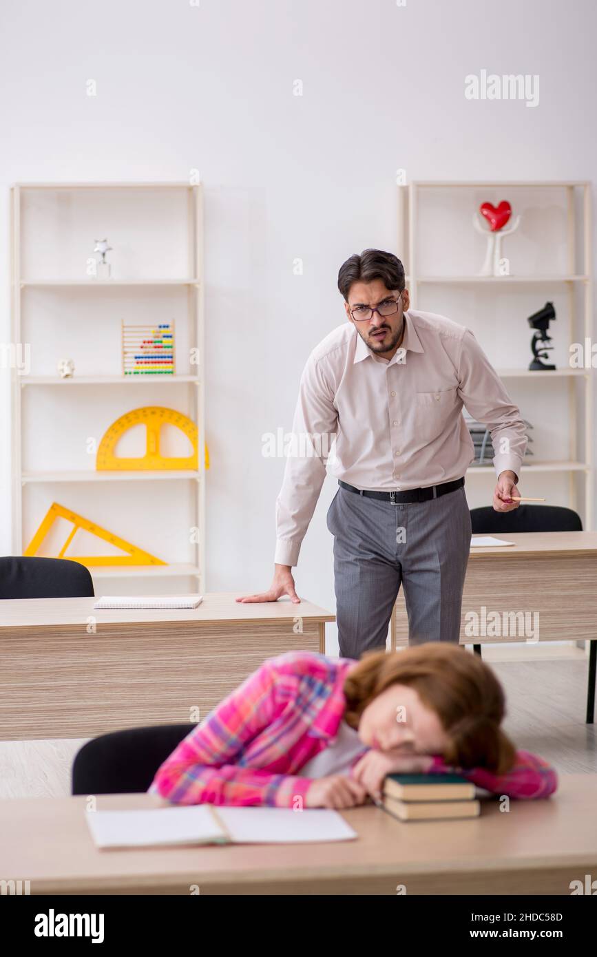 Young teacher and redhead girl in the classroom Stock Photo - Alamy