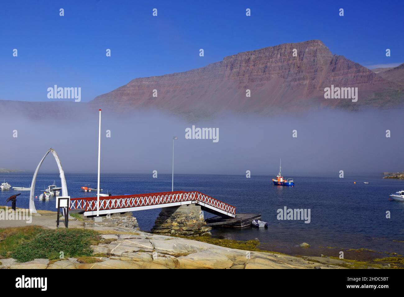 Cloud wall, red volcanic rock, whalebone gate, Disko Island, Disko Bay ...