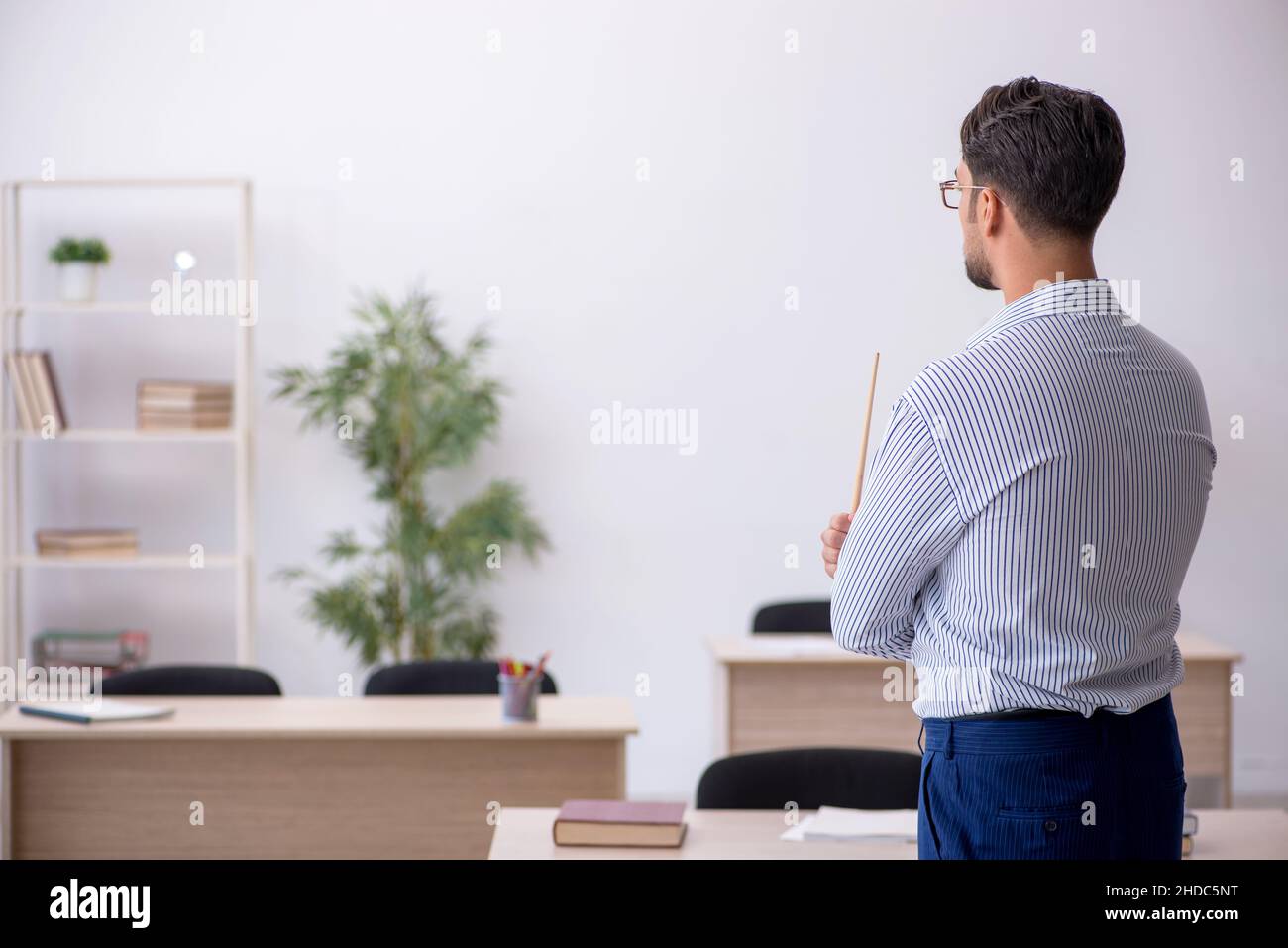 Young teacher in the classroom Stock Photo - Alamy