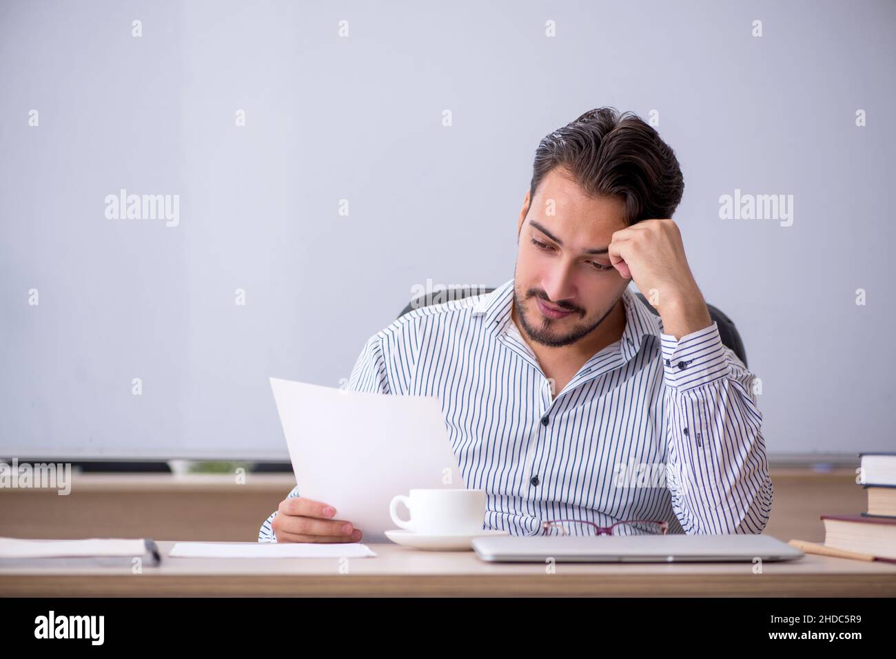 Young teacher in the classroom Stock Photo - Alamy