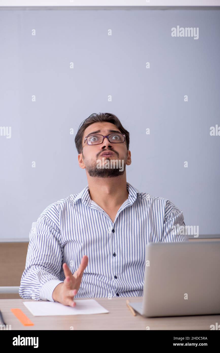 Young teacher in the classroom Stock Photo - Alamy