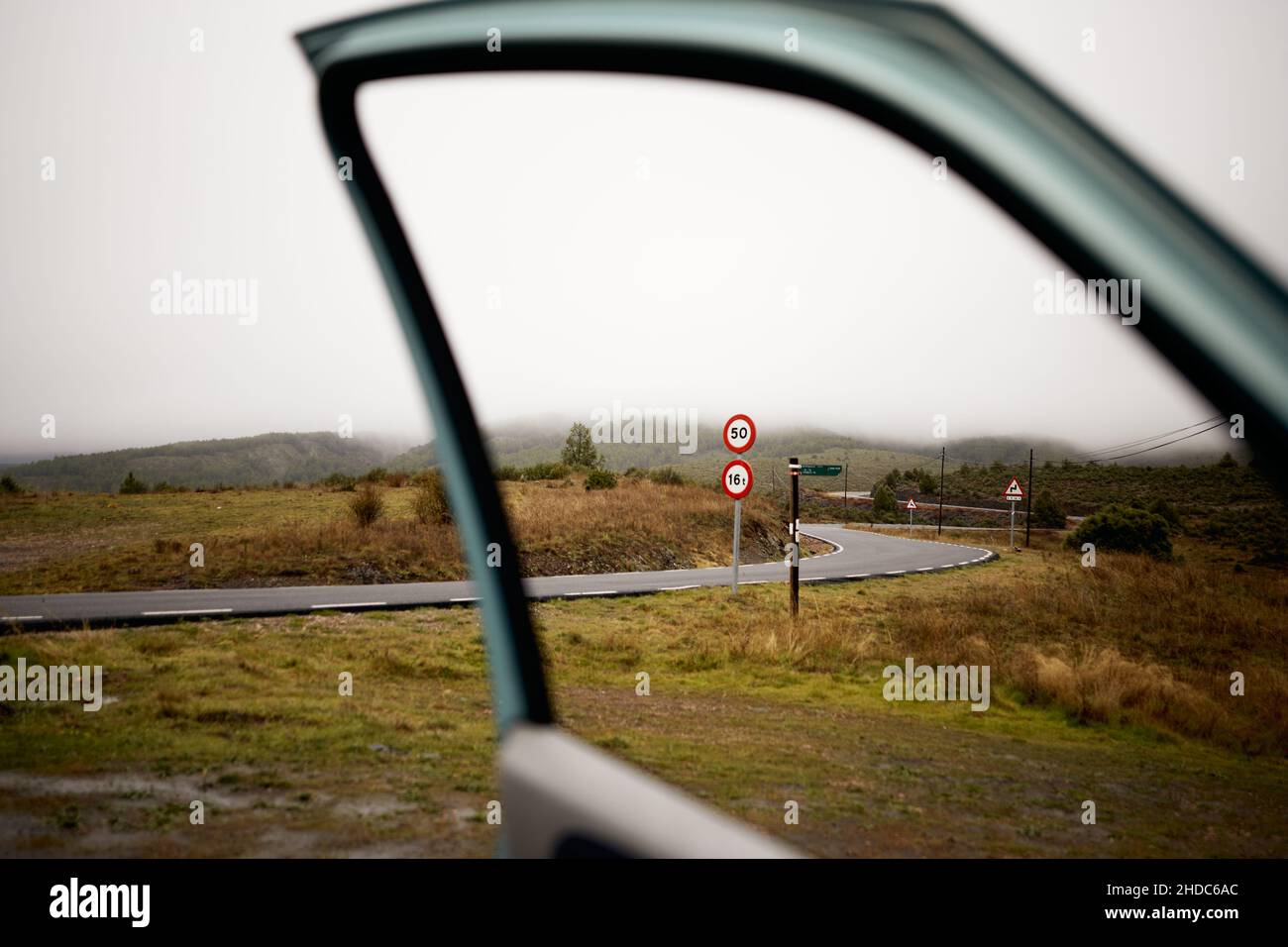 View through a car window of a road with direction and speed limit ...