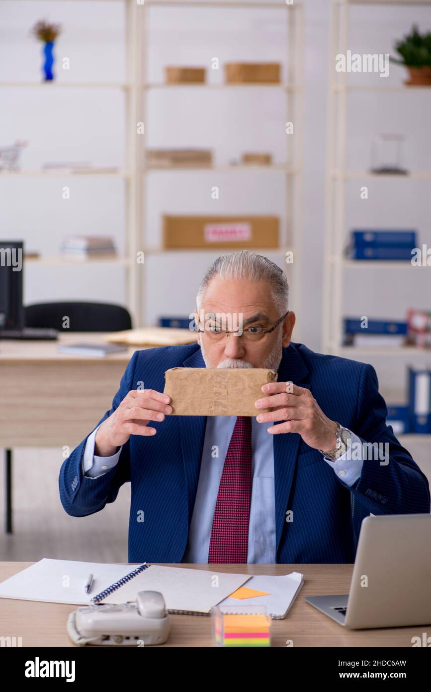 Old businessman employee ordering box via Internet Stock Photo - Alamy