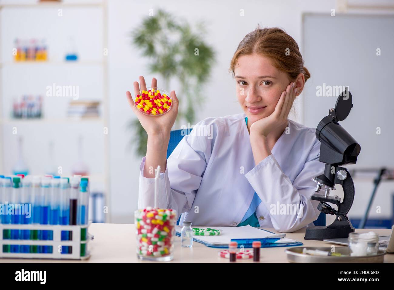 Young girl chemist in drugs synthesis concept Stock Photo - Alamy