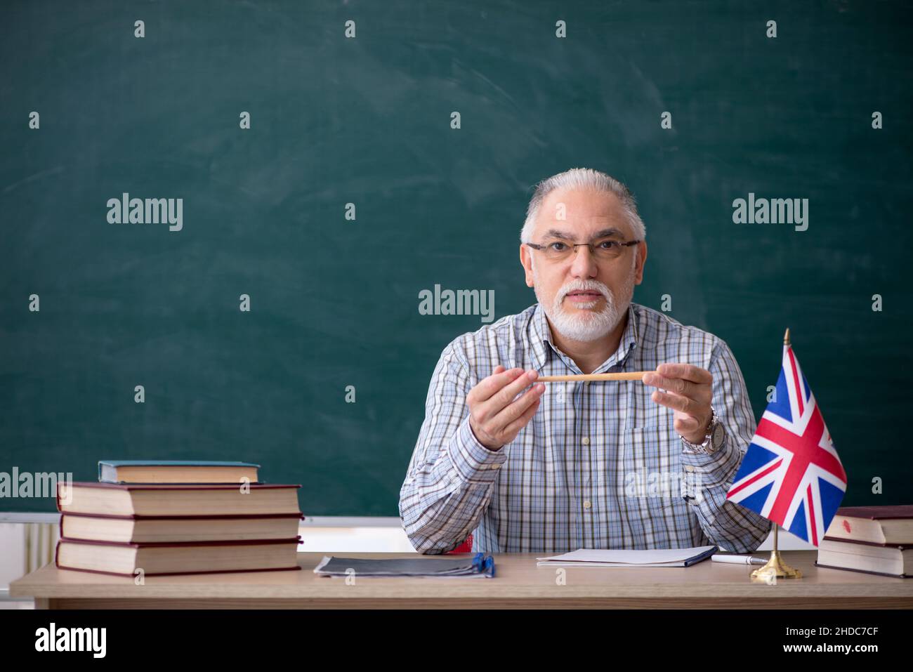 Aged english language teacher in the classroom Stock Photo - Alamy