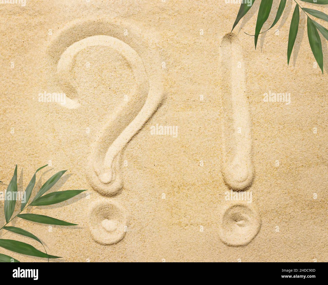 A question mark and an exclamation mark painted on the beach sand under ...