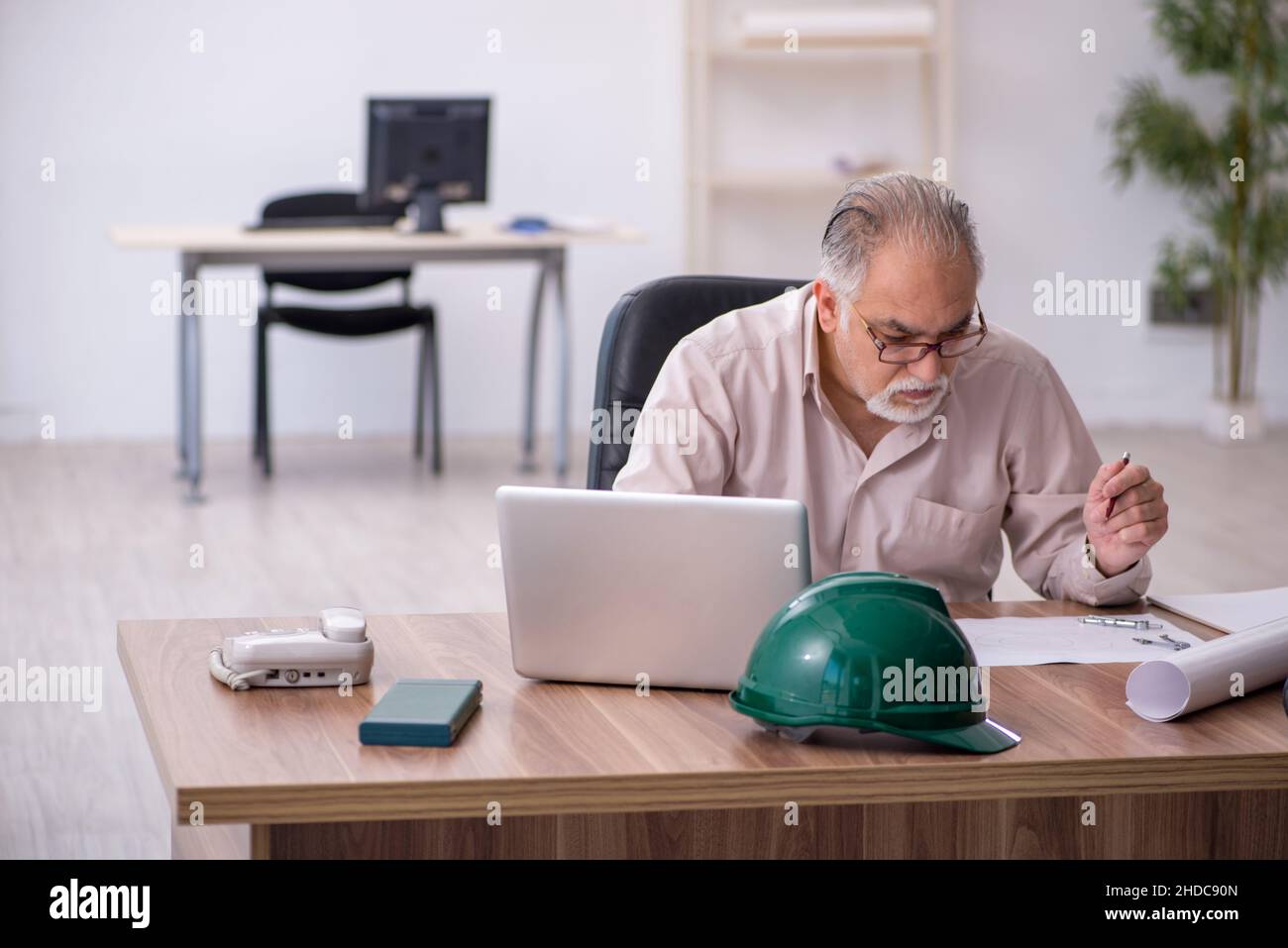 Old architect working in the office Stock Photo - Alamy
