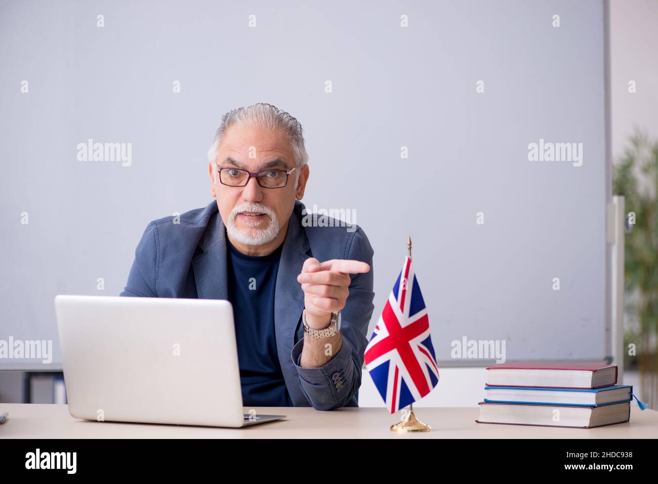 Old english language teacher in the classroom Stock Photo - Alamy