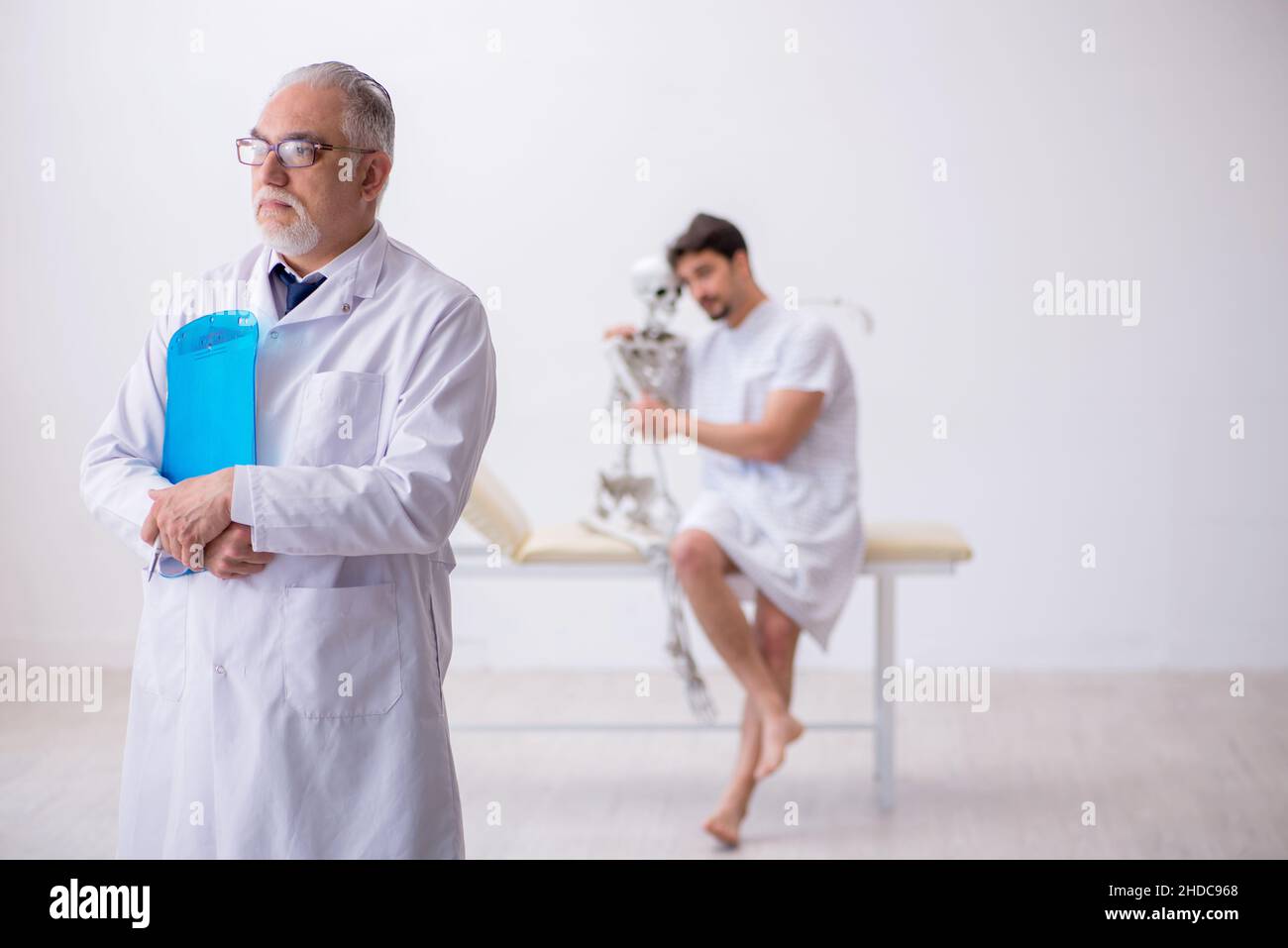 Old doctor psychiatrist examining young male patient Stock Photo - Alamy
