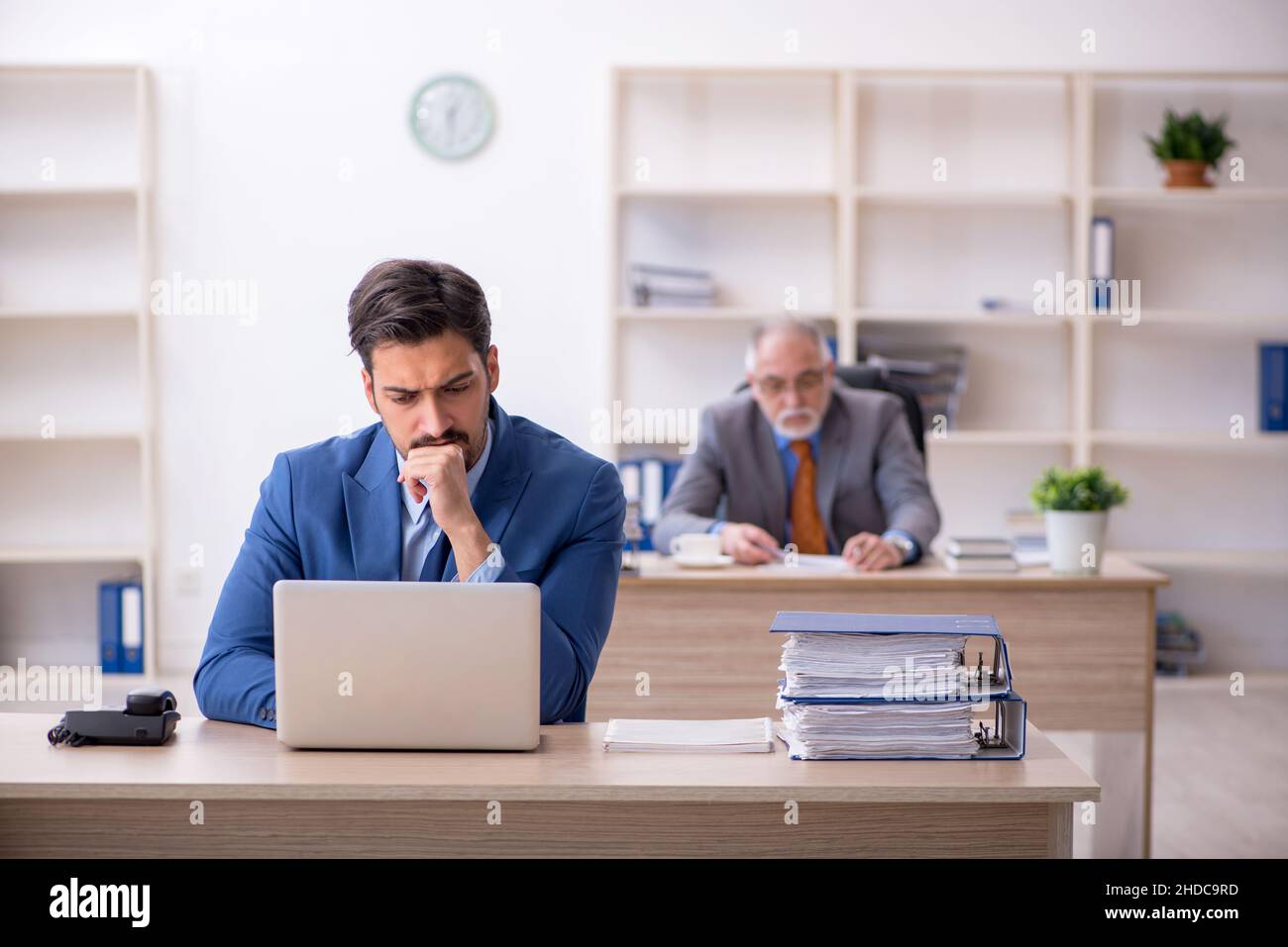 Two colleagues working at workplace Stock Photo - Alamy
