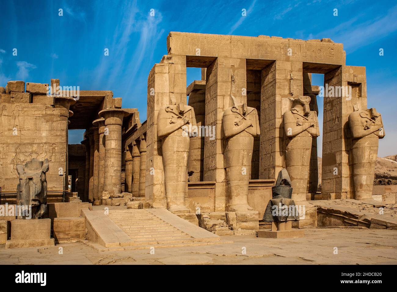 2nd courtyard with statues of Osiris, in front head of a statue of ...