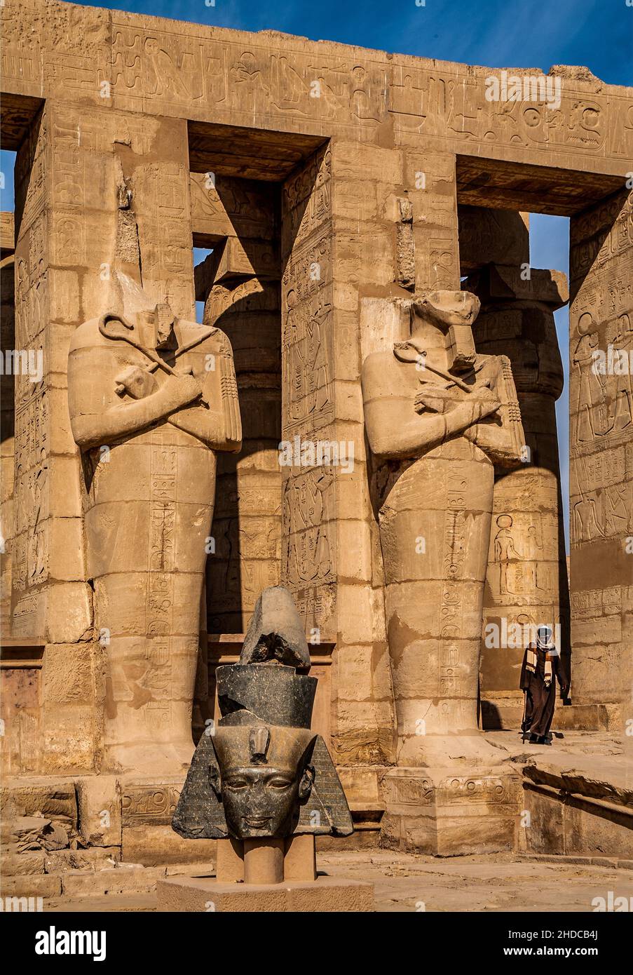 2nd courtyard with statues of Osiris, in front head of a statue of ...