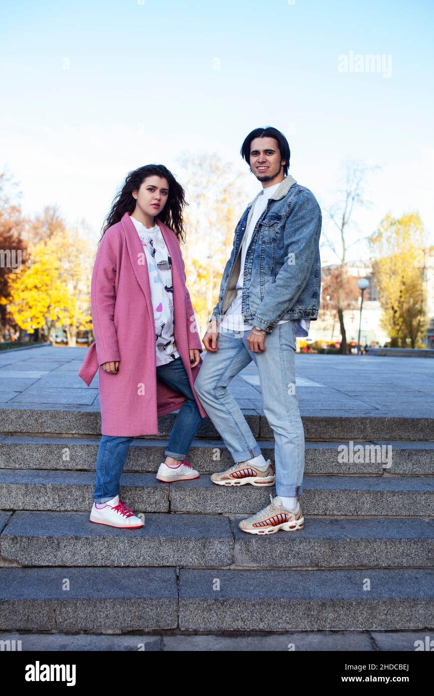 young happy students teenagers at university building on stairs ...