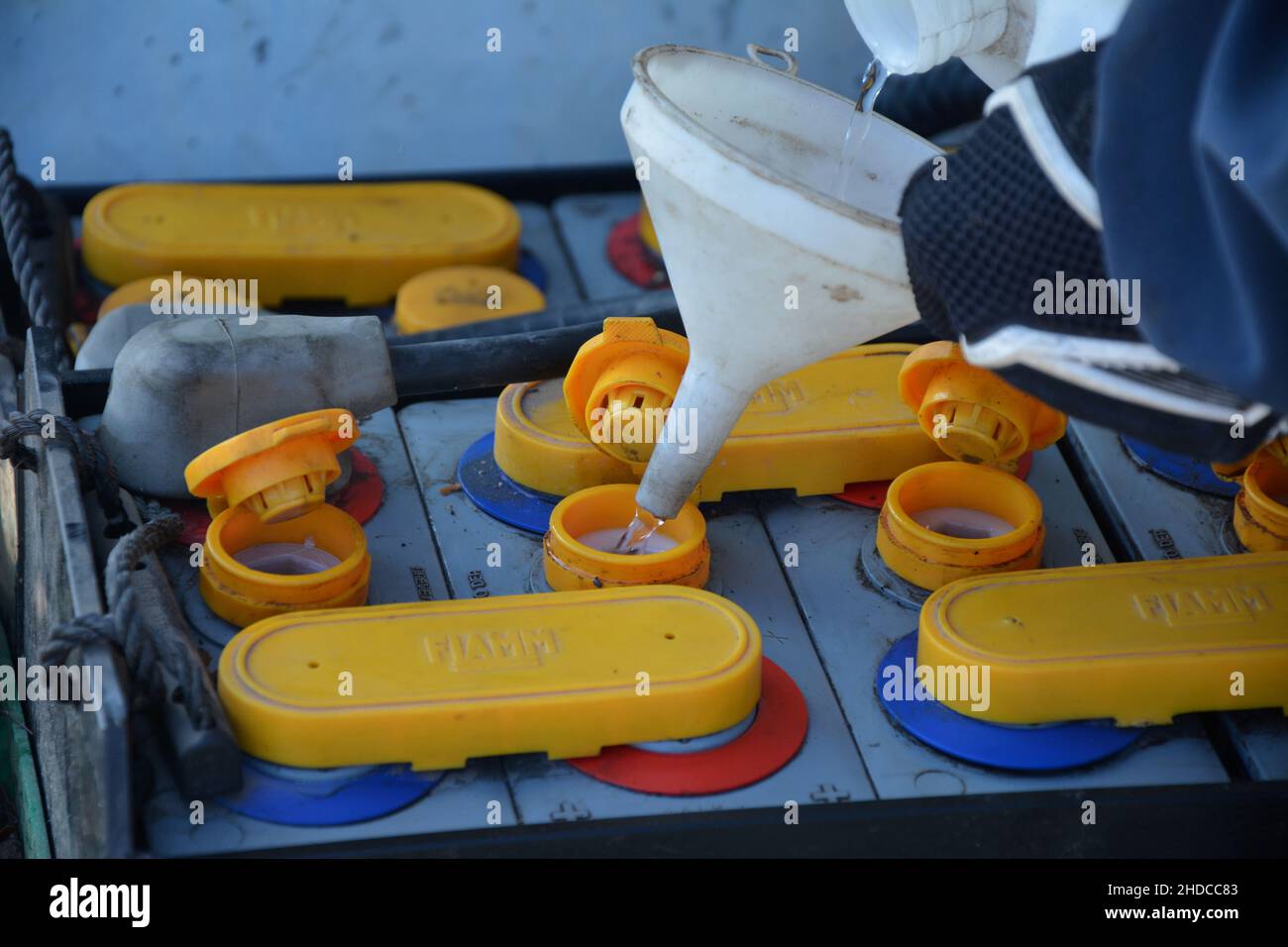 Maintaining a lithium battery with distilled water Stock Photo - Alamy