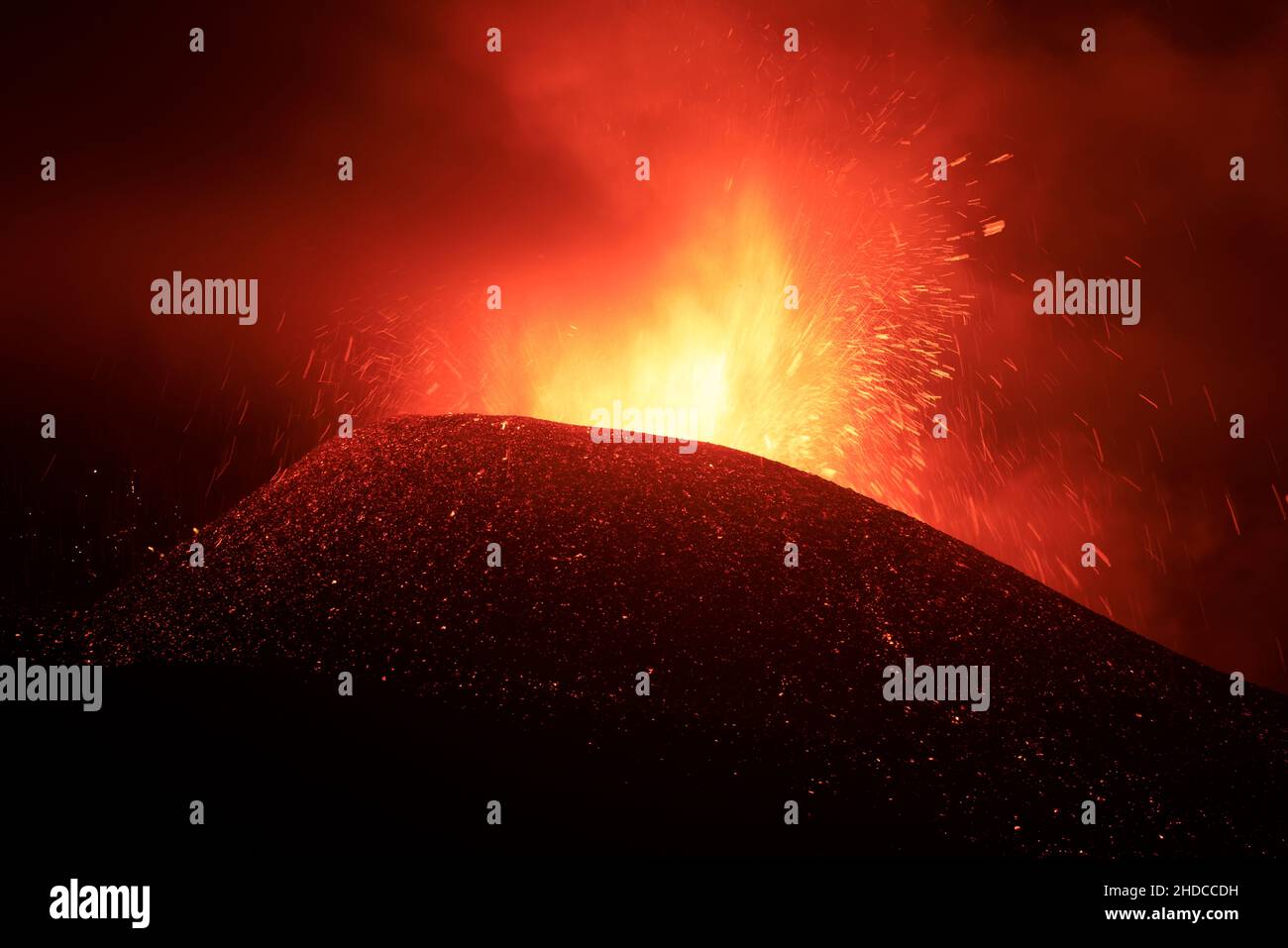 volcanic eruption expelling pyroclastic material at night Stock Photo ...