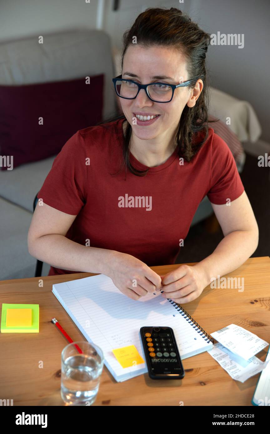 Cheerful small business owner smiling in conversation Stock Photo - Alamy