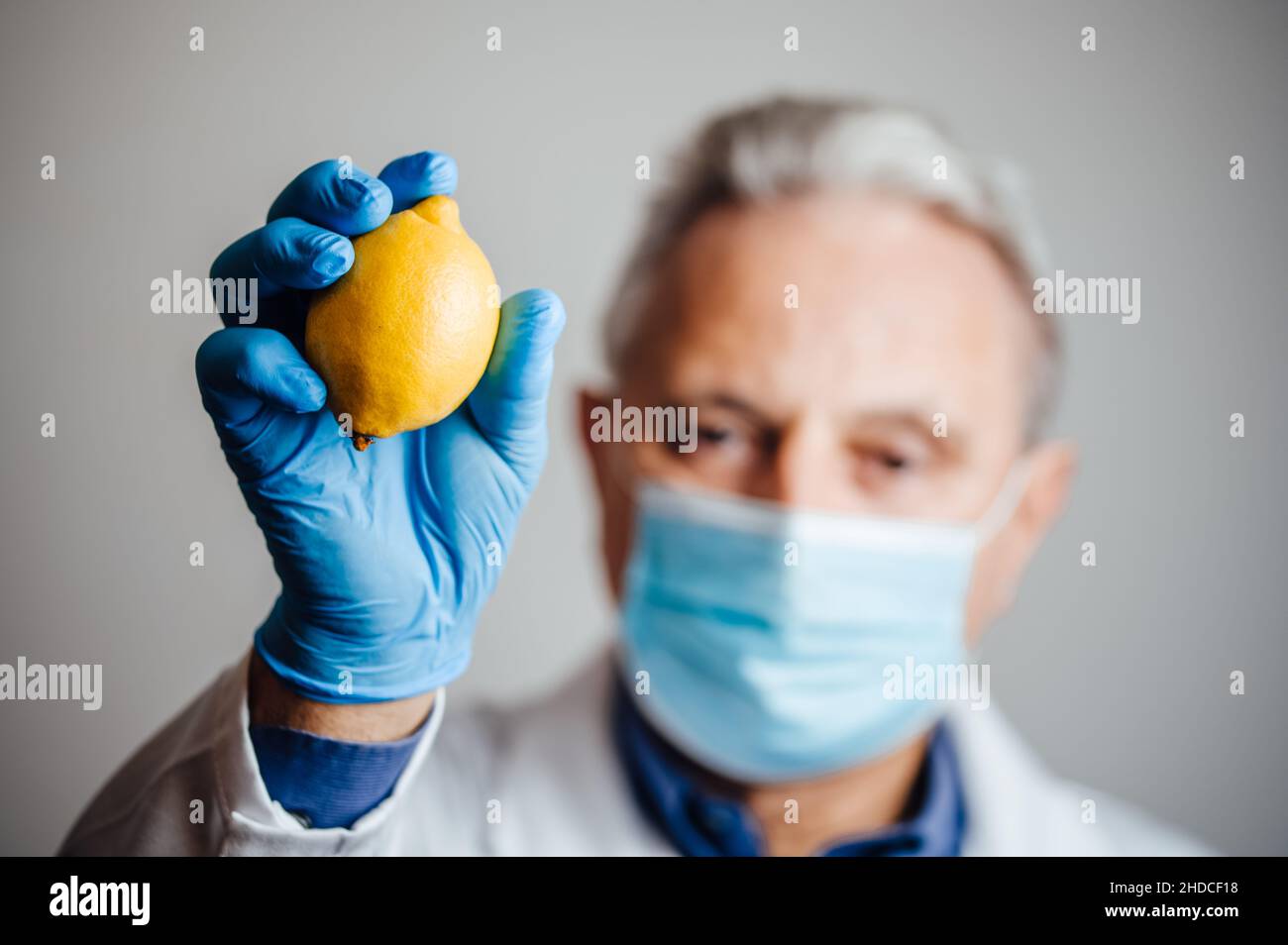 Medical doctor holding a lemon Stock Photo - Alamy