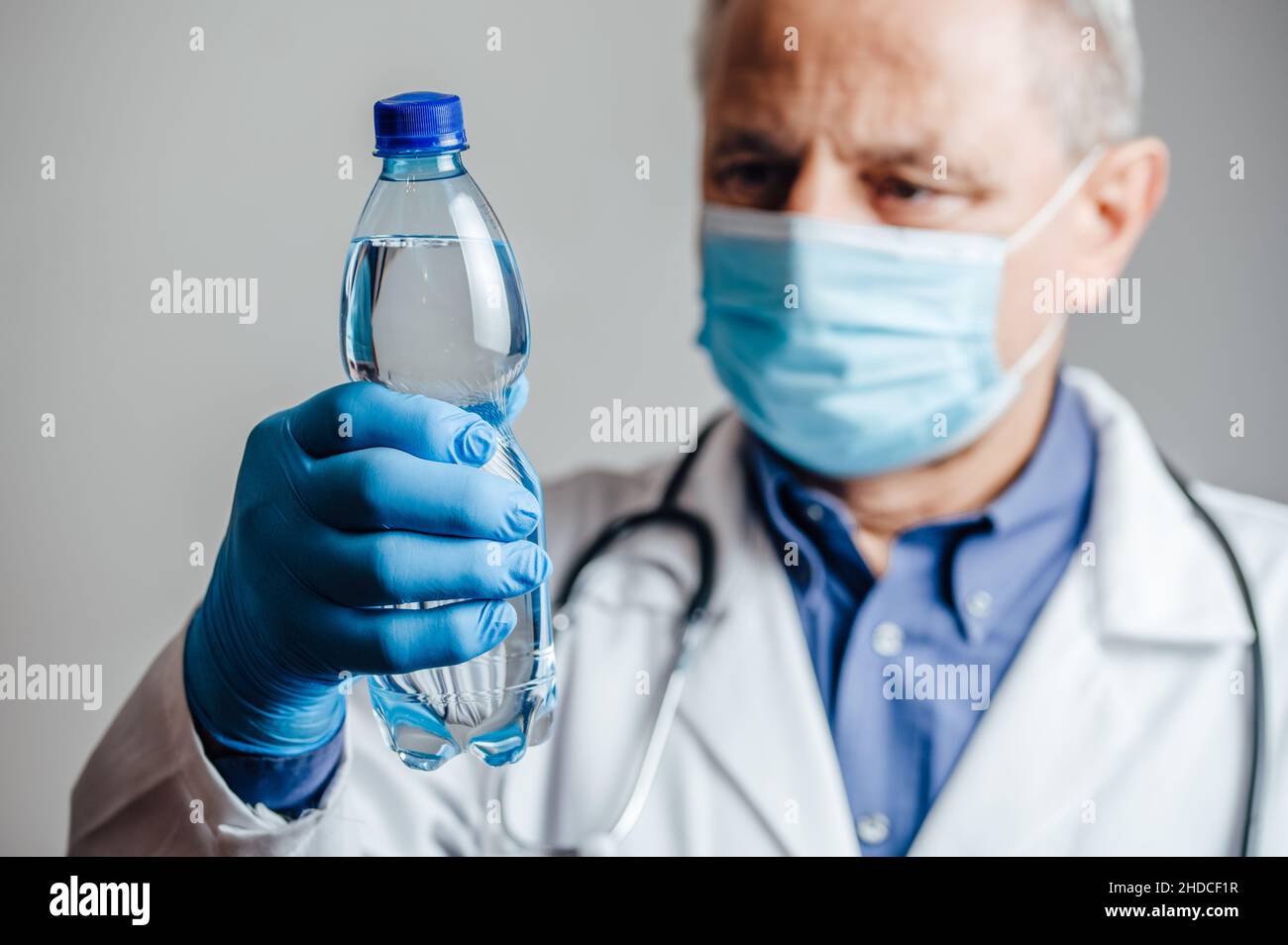 Medical doctor holding a bottle of water Stock Photo - Alamy