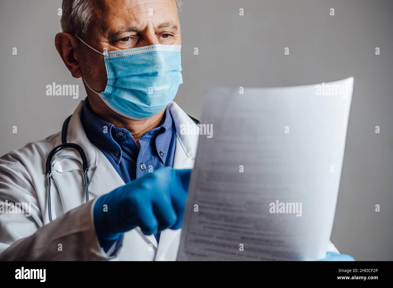 Medical doctor reading patient's test results Stock Photo - Alamy
