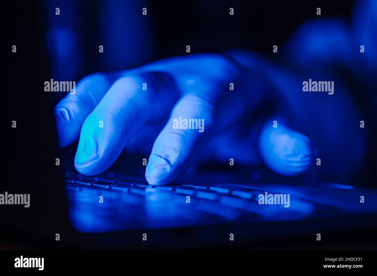 Hand with protective glove on a laptop keyboard Stock Photo - Alamy